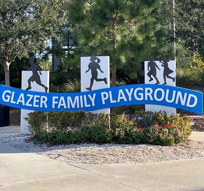 The welcoming signage features silhouettes of running children, perfectly capturing the energy you'll find inside this playground paradise.