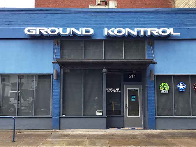 That unassuming blue exterior hides a neon-soaked wonderland where your inner teenager gets to come out and play again.