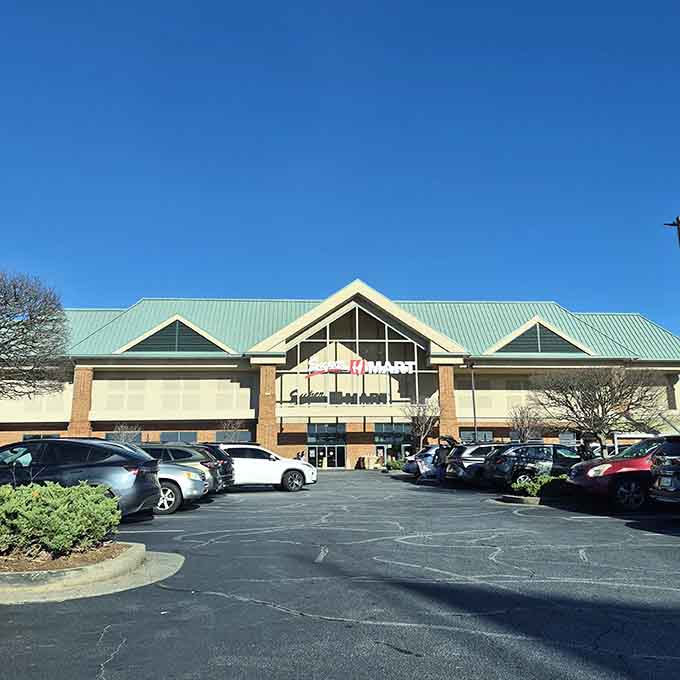 The bustling parking lot on a sunny afternoon tells you everything about this market's popularity with smart shoppers.