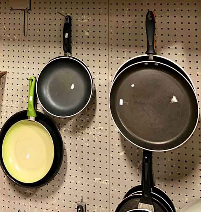 Quality cookware hanging ready for action, because even Julia Child would approve of these thrifty kitchen finds.