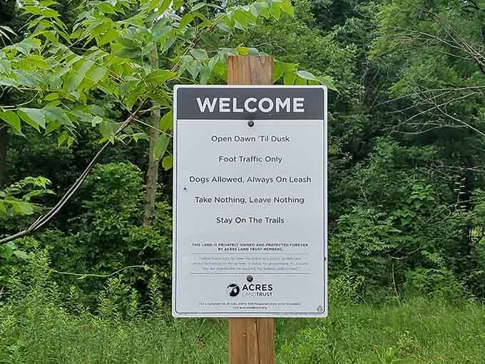 This welcoming sign sets expectations perfectly: come enjoy, but leave only footprints behind when you go.