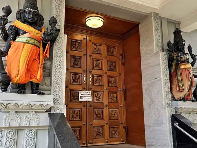 These ornate doors flanked by guardian figures mark the entrance to a sacred space that nourishes both body and soul beautifully.