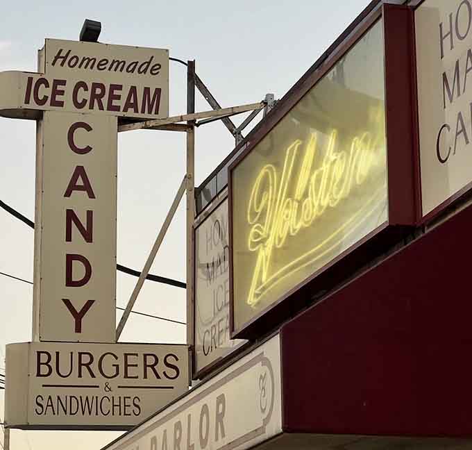 Vintage neon and hand-painted signs announce homemade ice cream, candy, burgers, and sandwiches with old-school pride.