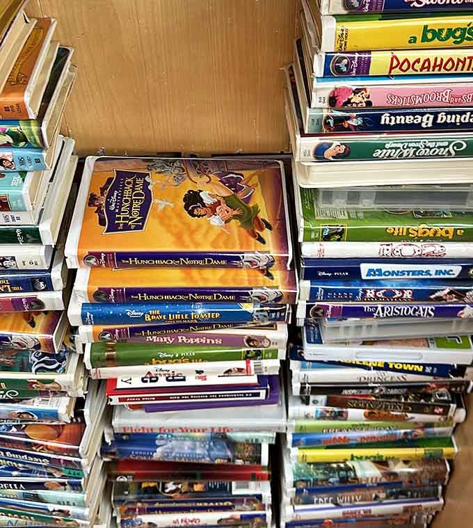 VHS tapes stack like archaeological evidence of entertainment's past, now available for nostalgic pennies.