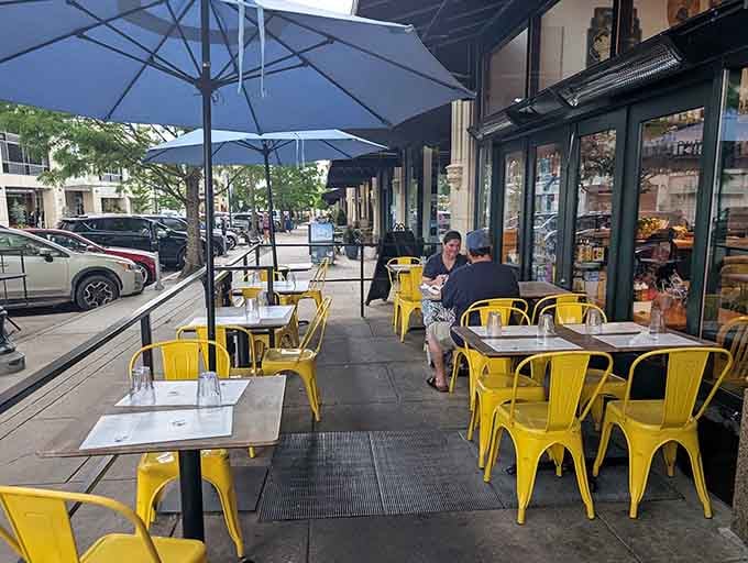 Outdoor seating with those signature yellow chairs, perfect for enjoying barbecue while watching downtown Asheville pass by.