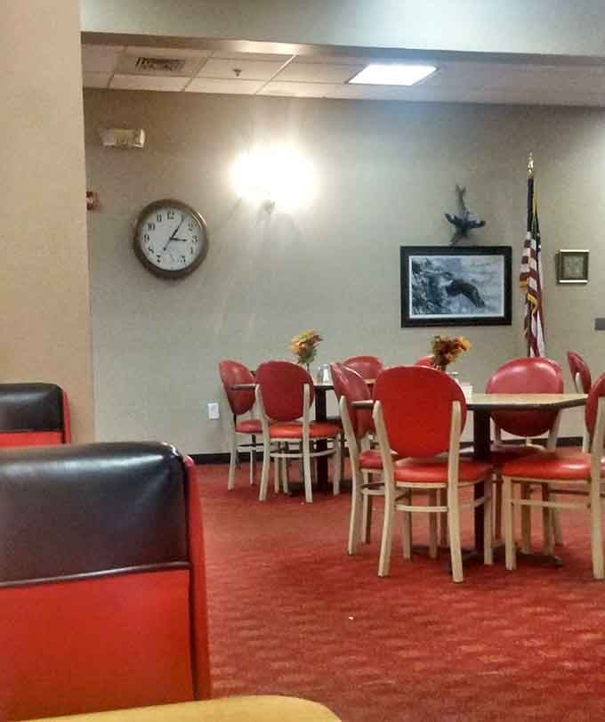 Additional seating areas with red chairs and framed artwork provide plenty of space for the lunch crowd to settle in.