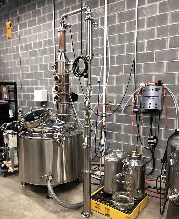 The gleaming copper still is where science meets art, transforming simple ingredients into extraordinary spirits.