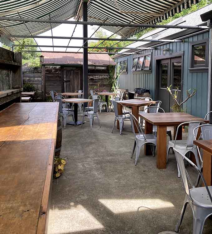 Outdoor seating under striped awnings where you can enjoy your meal while pretending you've temporarily escaped all adult responsibilities.