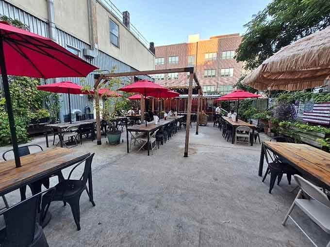 The outdoor patio with red umbrellas offers a breezy escape for enjoying Kansas City-style barbecue under open skies.