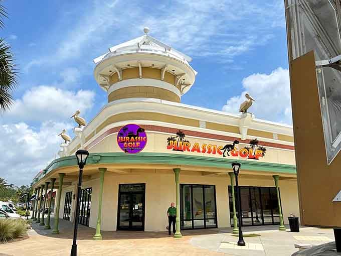 The exterior promises adventure with coastal charm, where pelicans perch above a world of indoor wonders.