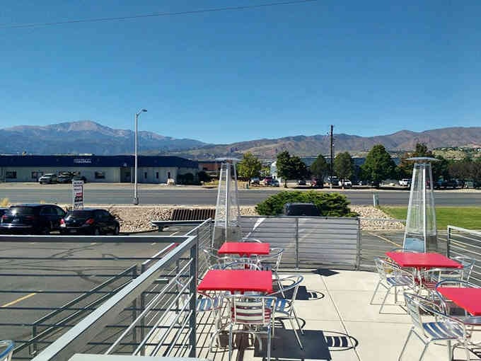 Mountain views and outdoor seating prove that even superheroes appreciate fresh air with their coffee and comics.