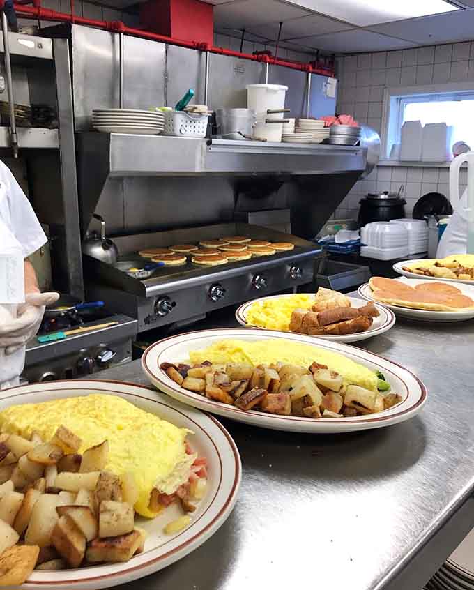 Behind the scenes where the magic happens, with omelets and hash browns sizzling on the griddle simultaneously.
