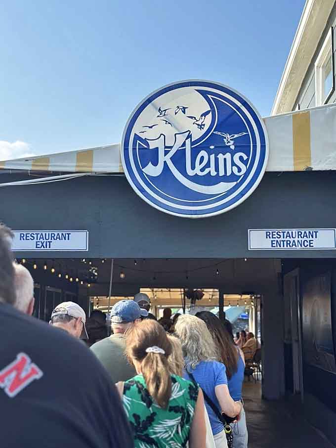 Klein's distinctive blue logo welcomes the crowd that knows good seafood requires no reservation, just patience and appetite.