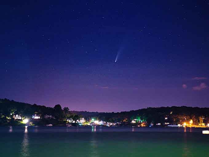 Stars and shoreline lights compete for attention in this nighttime scene that belongs on a postcard home.
