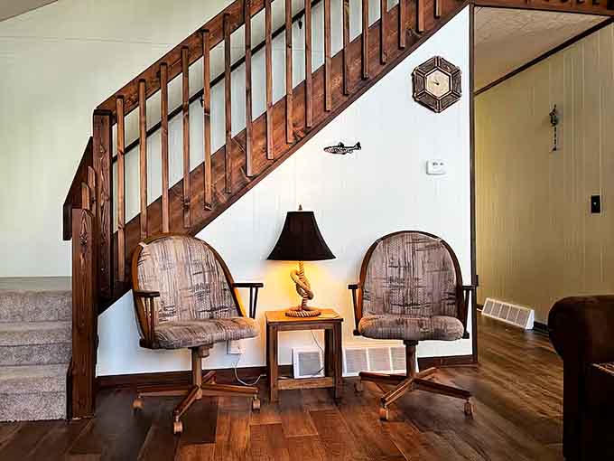 Those vintage swivel chairs under the stairs aren't just decor—they're your front-row seats to cottage life conversations.