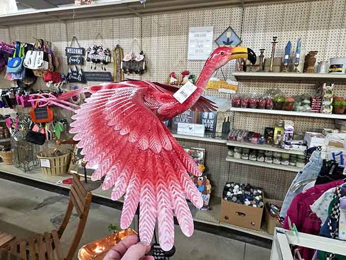 A vibrant pink flamingo sculpture spreads its wings, ready to bring tropical pizzazz to any Wisconsin garden brave enough.