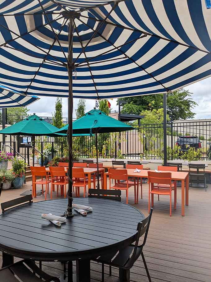 Outdoor seating with striped umbrellas because sometimes the best seafood tastes even better under Alabama skies.