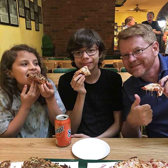 The universal language of pizza brings families together, one crispy square at a time, creating moments worth savoring forever.