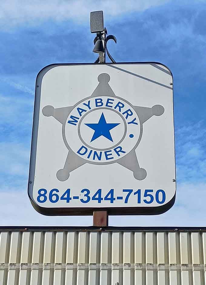 That sheriff's badge sign promises law, order, and seriously good sandwiches in equal measure at this roadside gem.