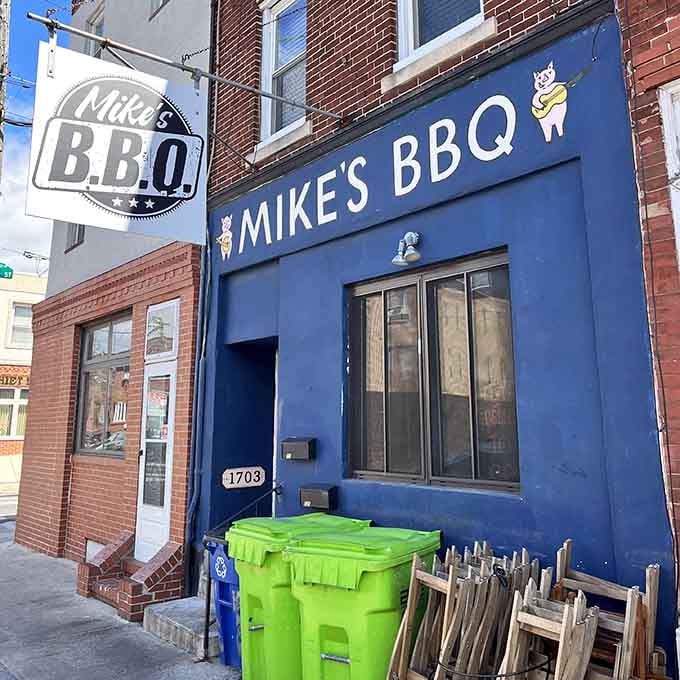The cheerful pig mascots on the sign promise good times ahead for anyone wise enough to walk through.