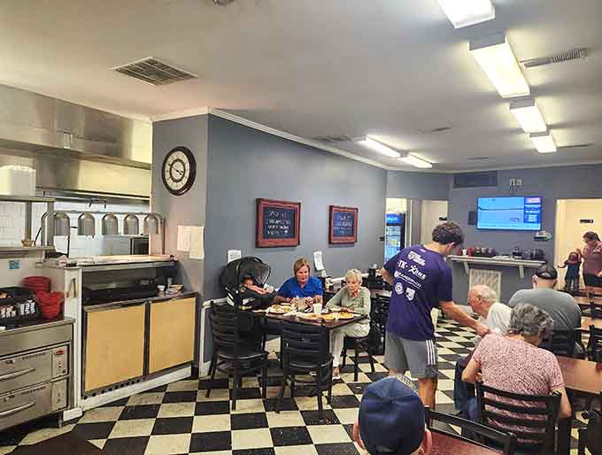 The full dining room buzzing with conversation shows what happens when a community finds its breakfast home.