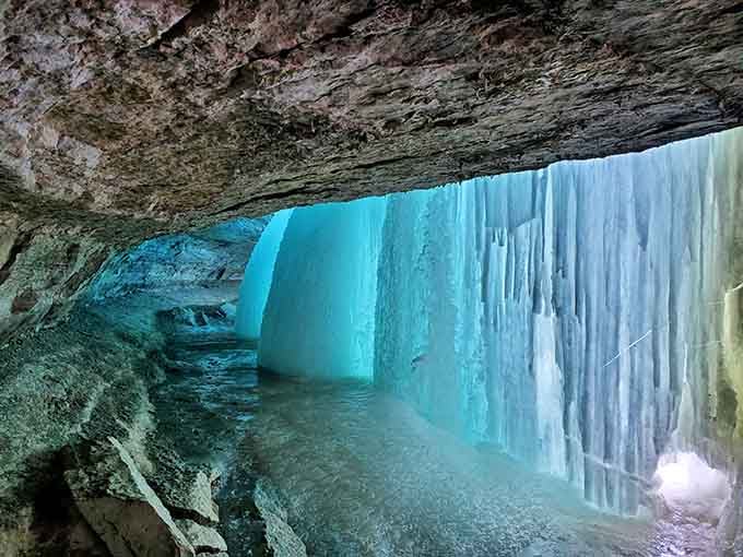 Walking behind a frozen waterfall feels like discovering Narnia, except you can leave whenever your toes get cold.