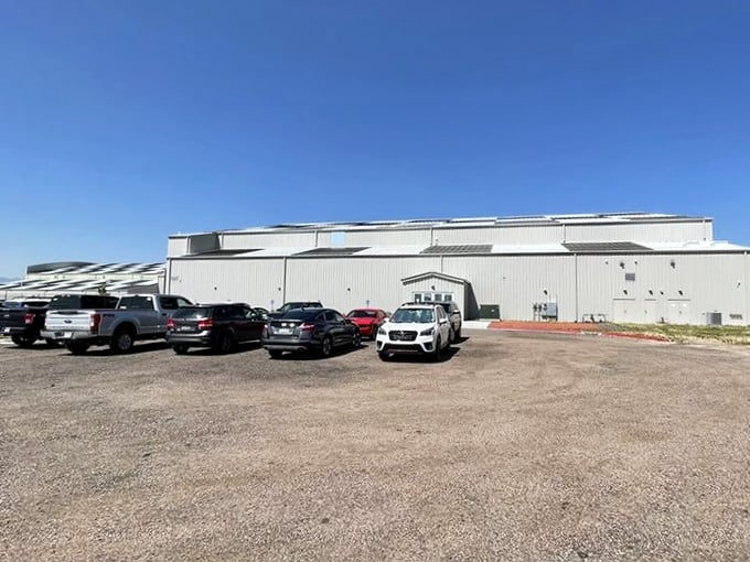 That gravel parking lot outside gives zero hints about the extraordinary aviation cathedral waiting just beyond those doors.