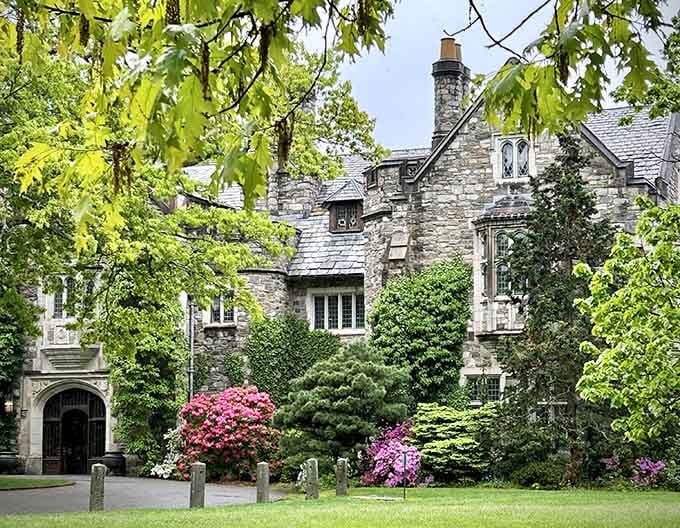 Skylands Manor standing majestically, surrounded by azaleas that steal the show every spring.