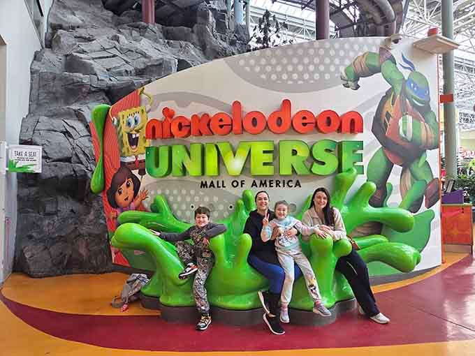 The official welcome sign where families gather to document their victory over winter and common sense alike.