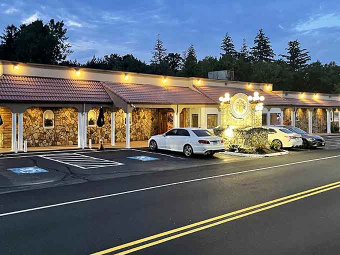 Evening lights illuminate a welcoming facade that promises good food without the pretension of places requiring reservations three months ahead.