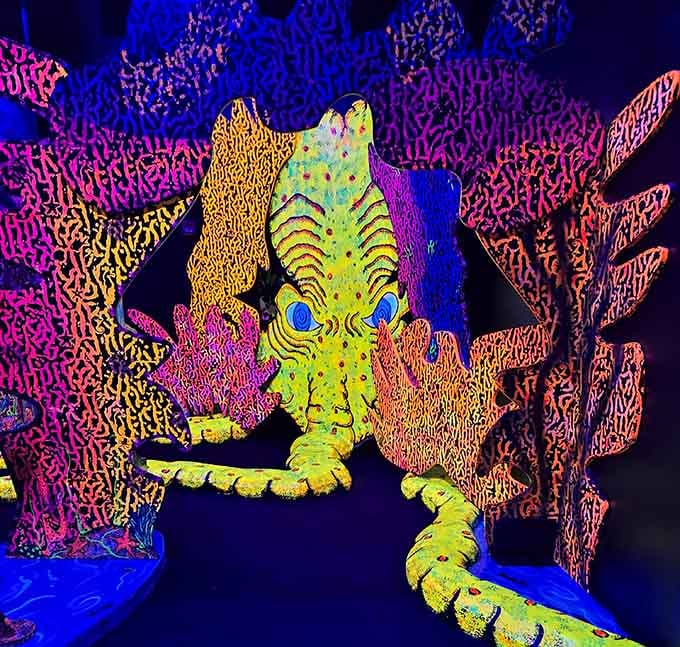 Glowing sea creature guards a neon mini golf hole, where vibrant colors turn every swing into adventure.
