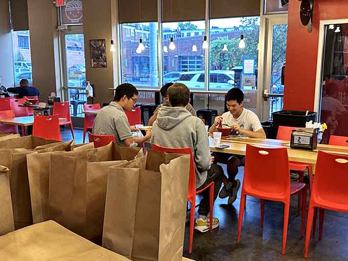 Diners hunched over their bowls in concentrated bliss, the universal posture of serious noodle appreciation.