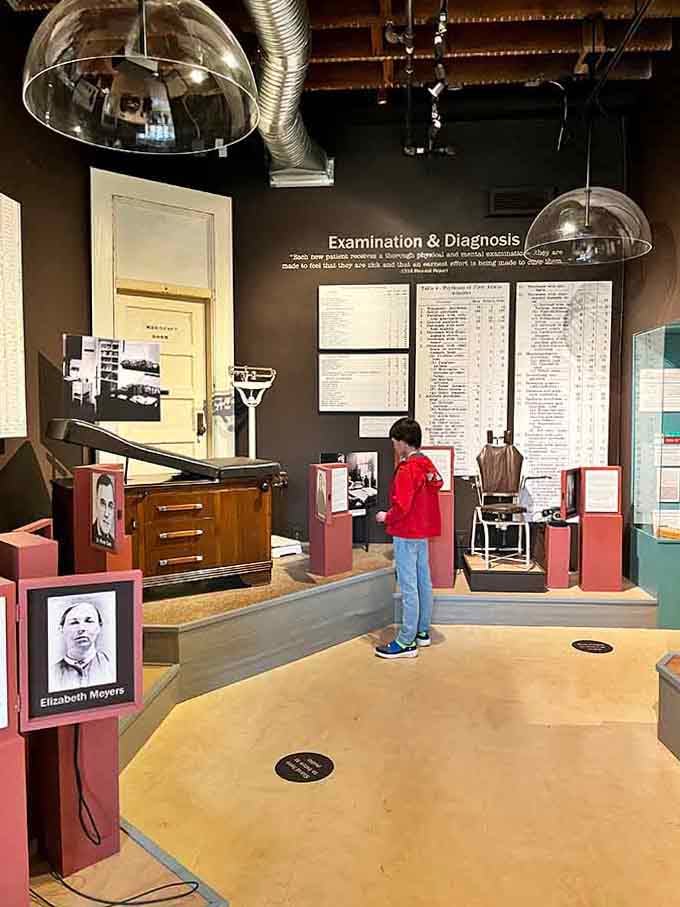 Interactive examination room displays let visitors explore diagnostic methods used throughout different psychiatric treatment eras.