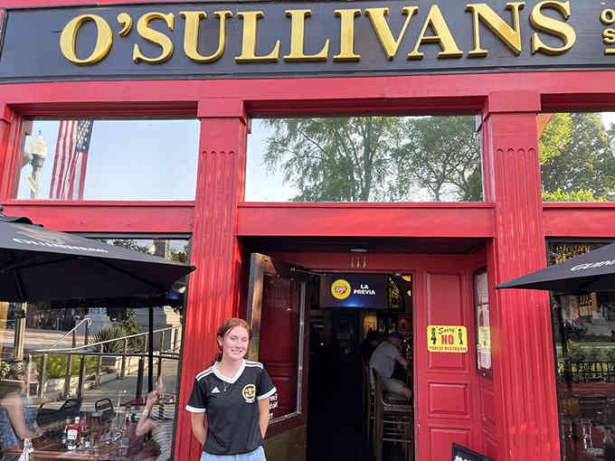 That bold red entrance beckons like a friendly wave, inviting you inside for pints and good times.