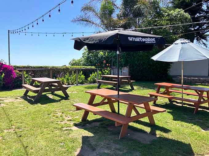 Picnic tables on the lawn where you can enjoy your tacos with coastal breezes included.