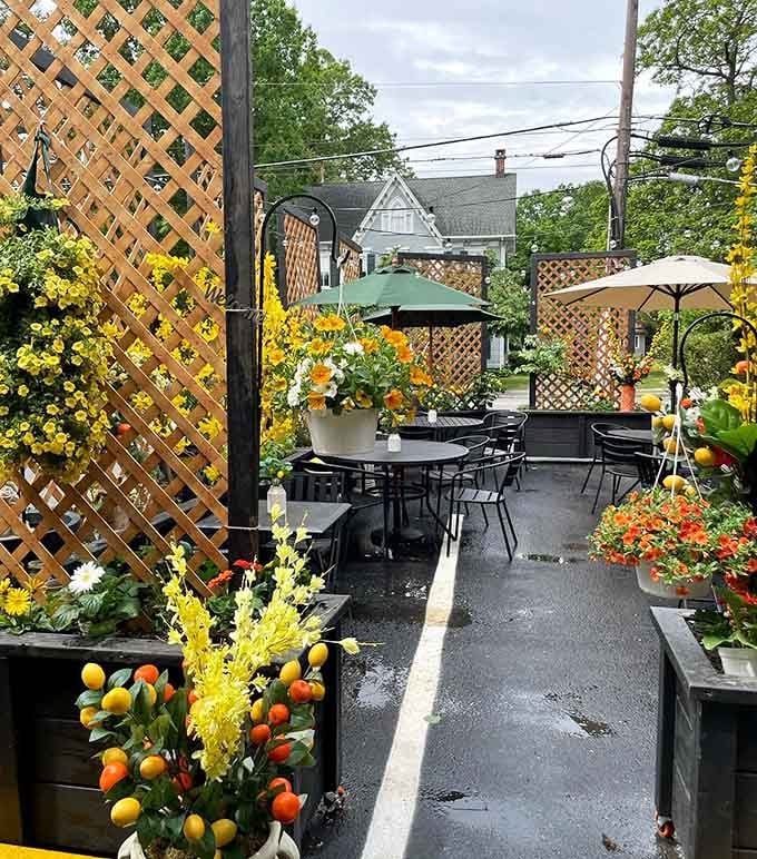 An outdoor patio bursting with flowers and sunshine, because sometimes the best Italian meals happen under open skies.