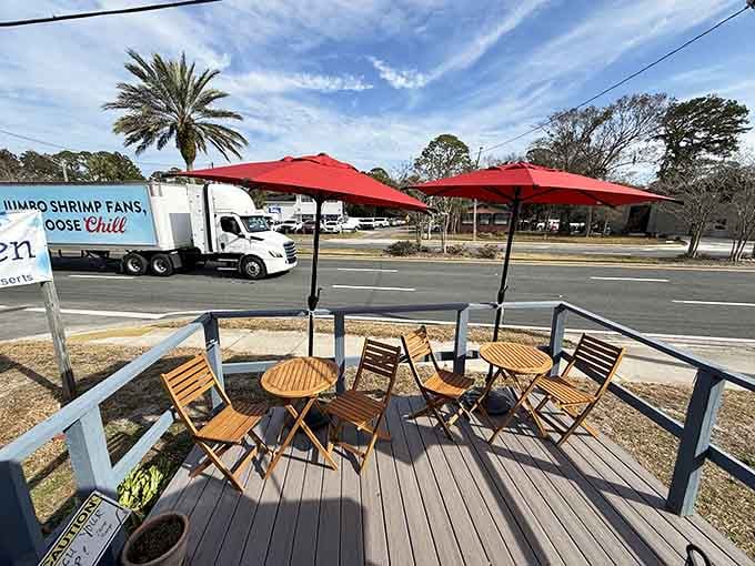 Outdoor seating under red umbrellas where you can enjoy pie with a side of sunshine.