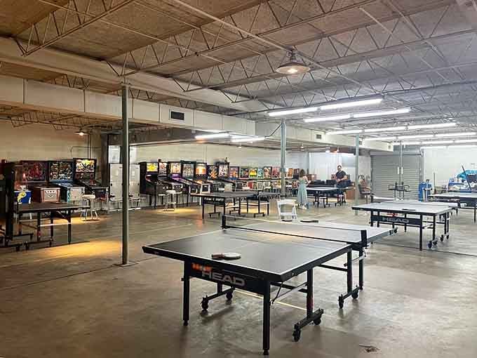 Table tennis stations stretch across the warehouse floor, offering analog competition that never requires a software update.