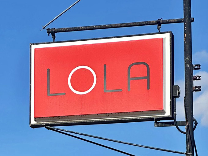 Simple, bold, unforgettable, just like the pizza waiting inside beneath this iconic red sign.