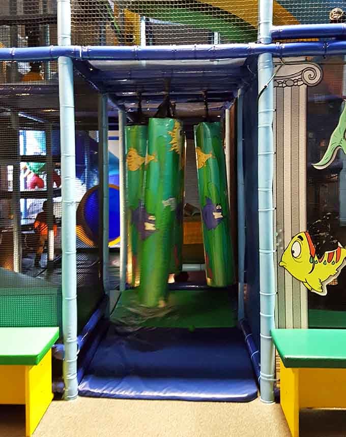 Hanging obstacles with ocean-themed curtains create a sensory experience that's part jungle gym, part deep-sea diving expedition.