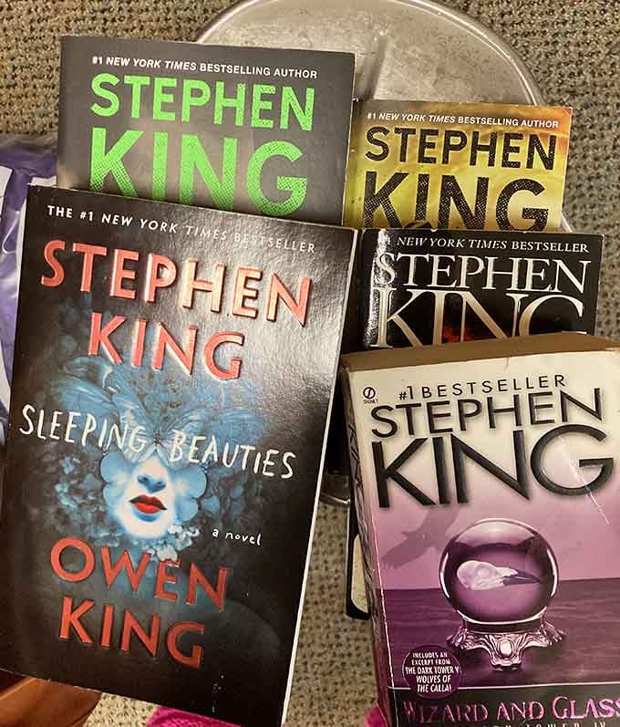 Stephen King novels stacked like treasure, ready to keep you up way past your intended bedtime.