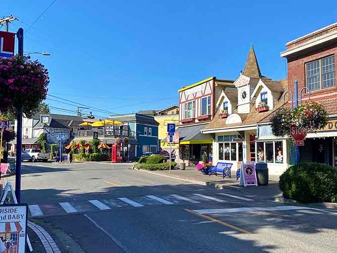 Flower baskets dangling above storefronts transform an ordinary street into something straight from a European travel documentary.