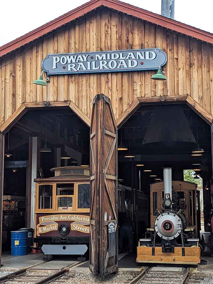 The barn proudly displays its name, housing both steam locomotive and vintage streetcar under one historic roof.