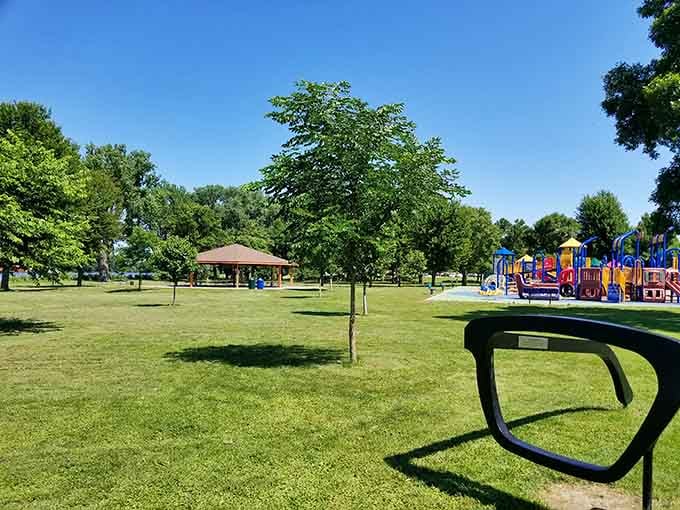 Colvill Park spreads green and inviting under summer sun, where playground laughter mingles with the rustle of mature trees.