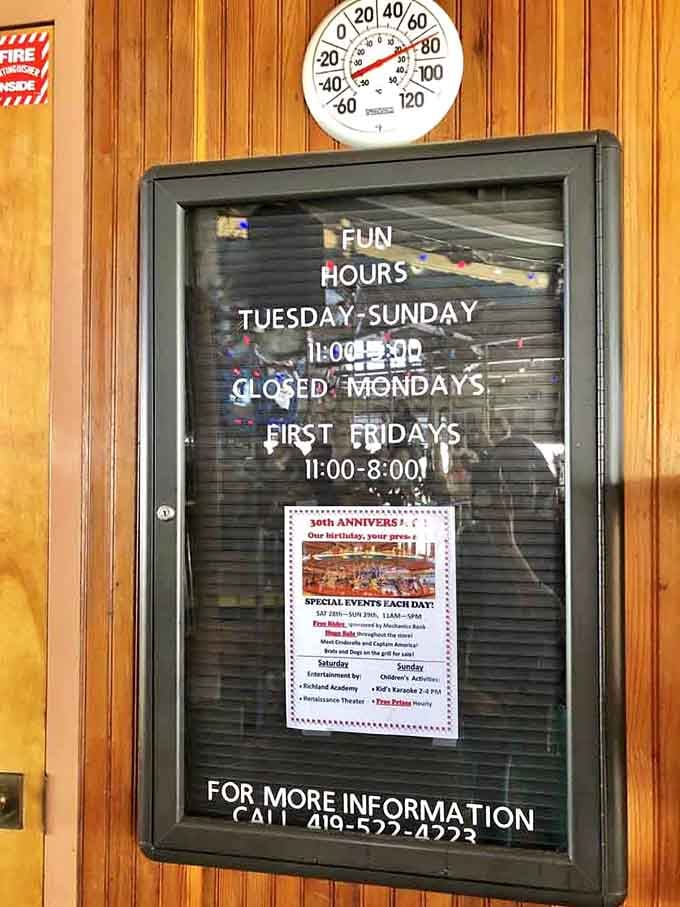 Operating hours posted on wood paneling remind you that even magical places need Mondays off to rest their horses.