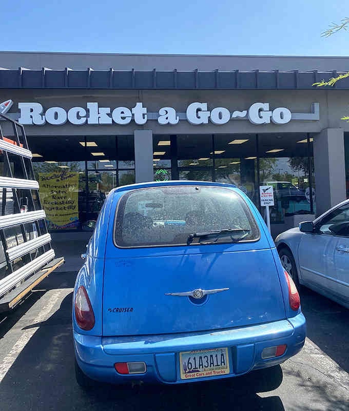 That little blue car knows what's up, parked right where the vintage magic happens daily.