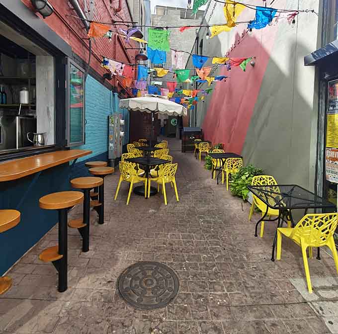 Outdoor seating under colorful papel picado banners, turning a simple meal into a fiesta worth celebrating properly.