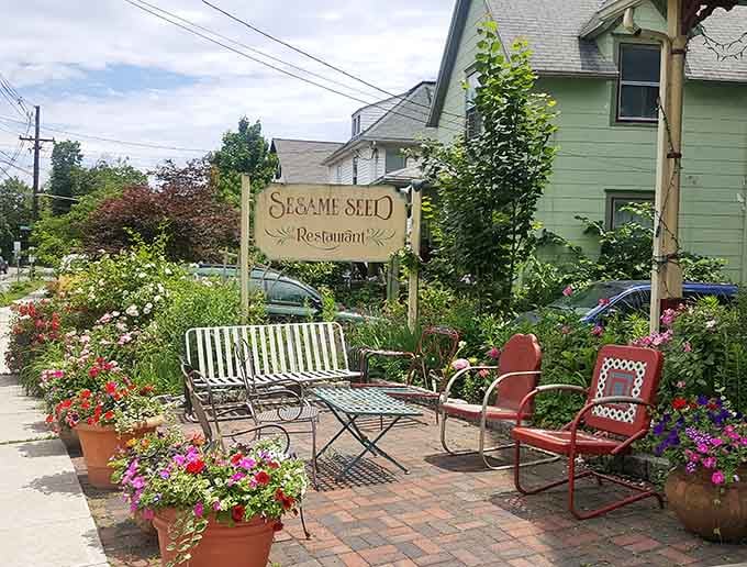 The charming outdoor seating area surrounded by flowers offers the perfect spot to digest your meal and plan your return visit.