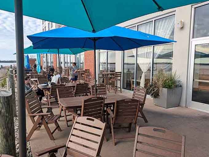 Wooden tables on the patio offer the perfect spot for soaking up sunshine while working through that delicious menu.