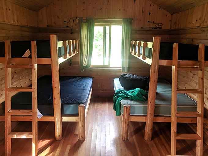 Inside a camper cabin where bunk beds and wood walls create that summer camp vibe without the awkward trust falls.